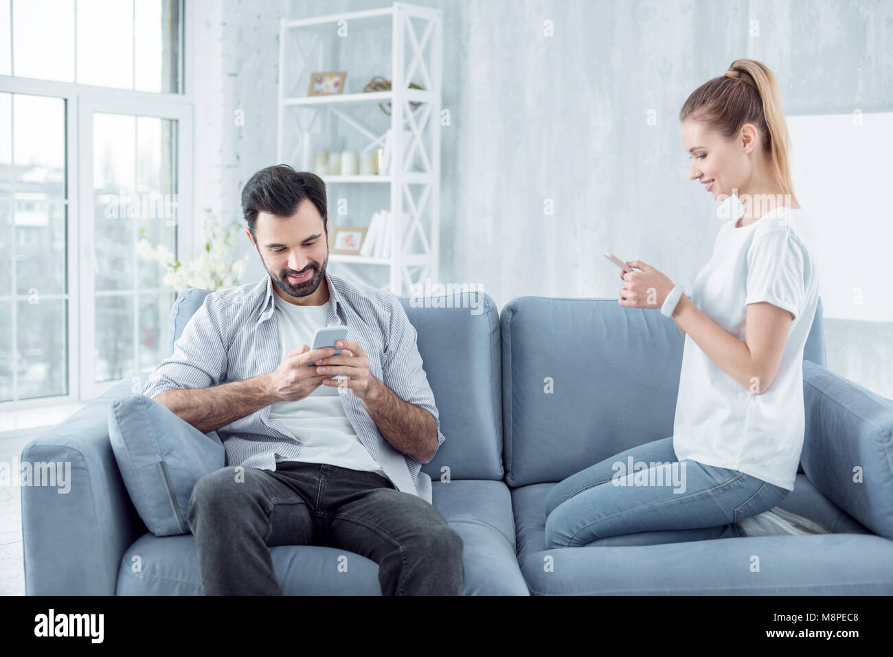 Pleased male person typing message Stock Photo - Alamy