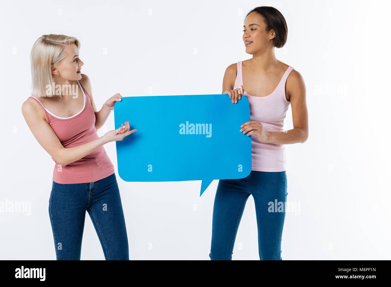 Positive joyful women talking to each other Stock Photo - Alamy