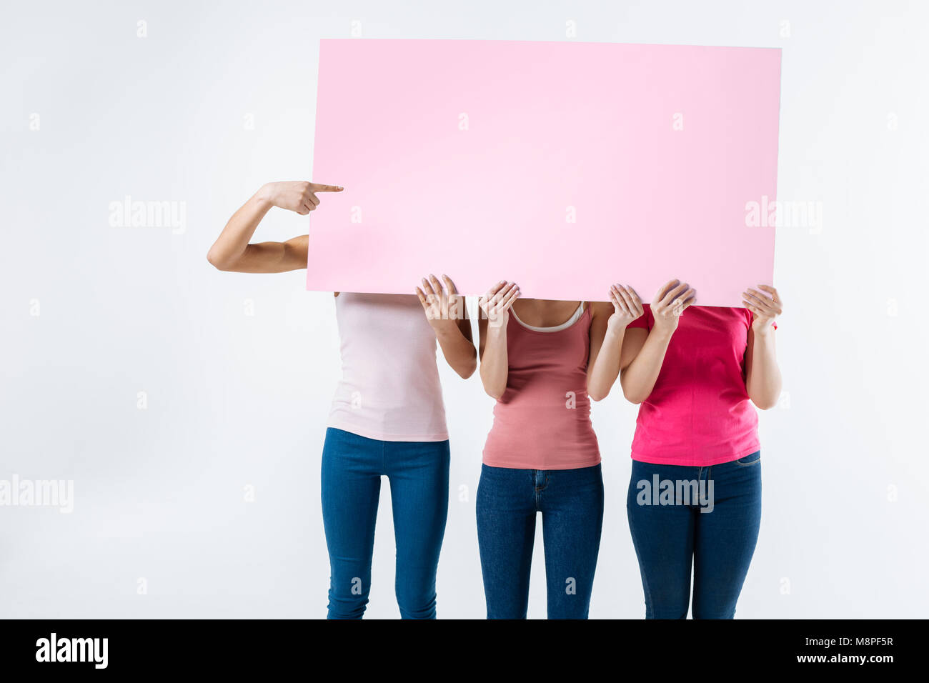 Nice blonde woman pointing at the poster Stock Photo - Alamy