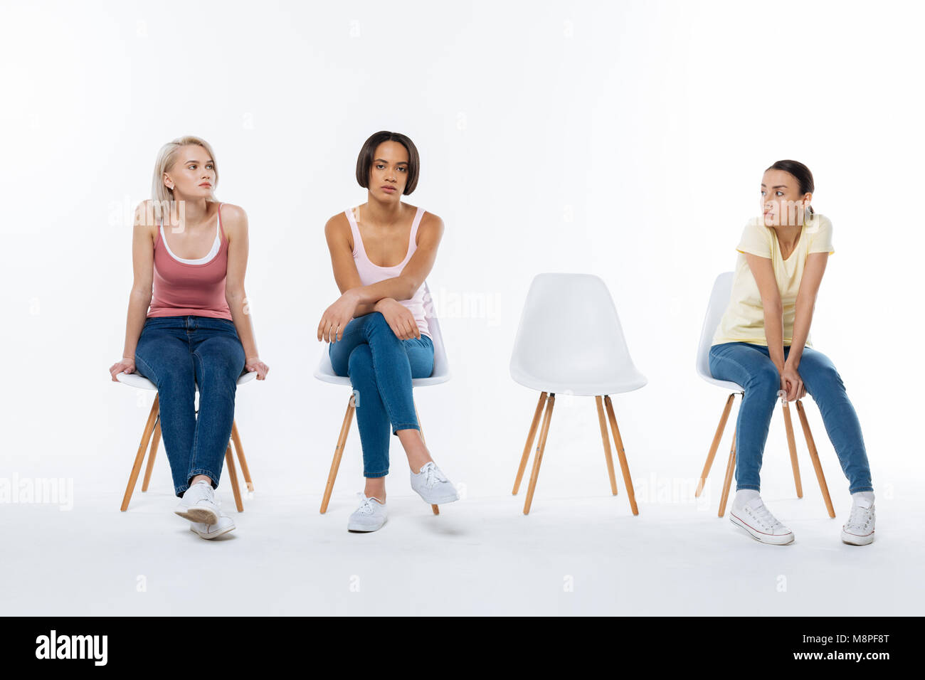 Serious young women waiting Stock Photo - Alamy