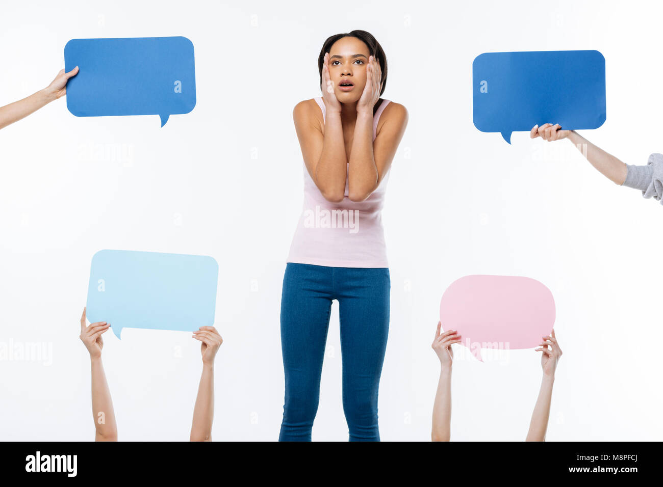 Nice young woman holding her cheeks Stock Photo - Alamy