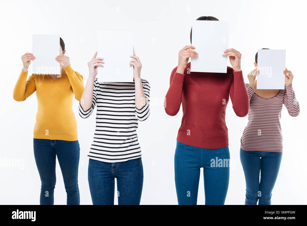 Pleasant young women holding paper sheets Stock Photo - Alamy