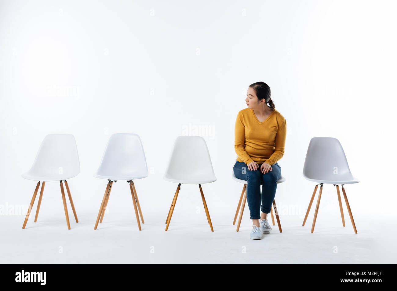 Nice pleasant woman looking around Stock Photo - Alamy