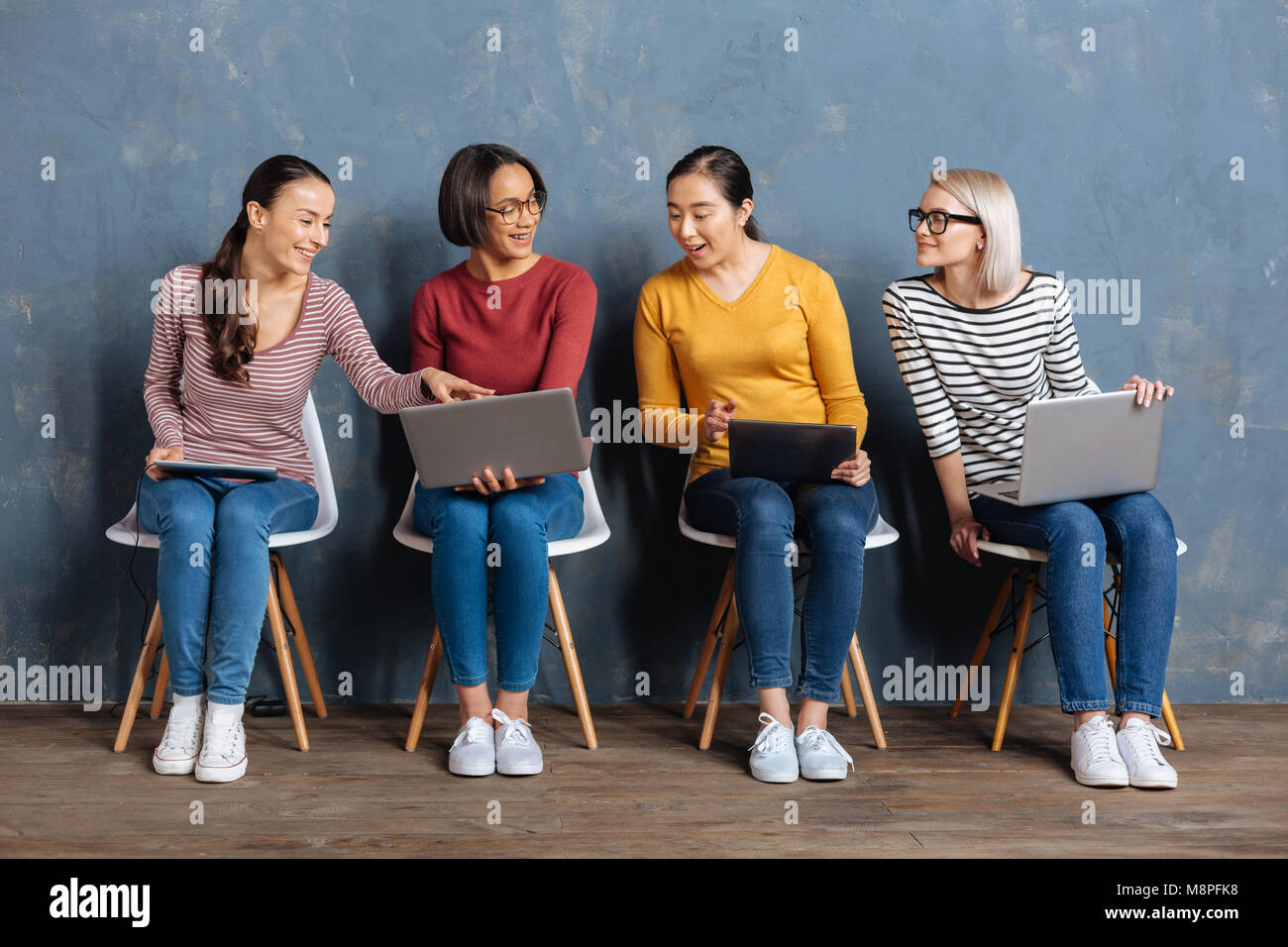 Positive cheerful woman pointing at the screen Stock Photo - Alamy