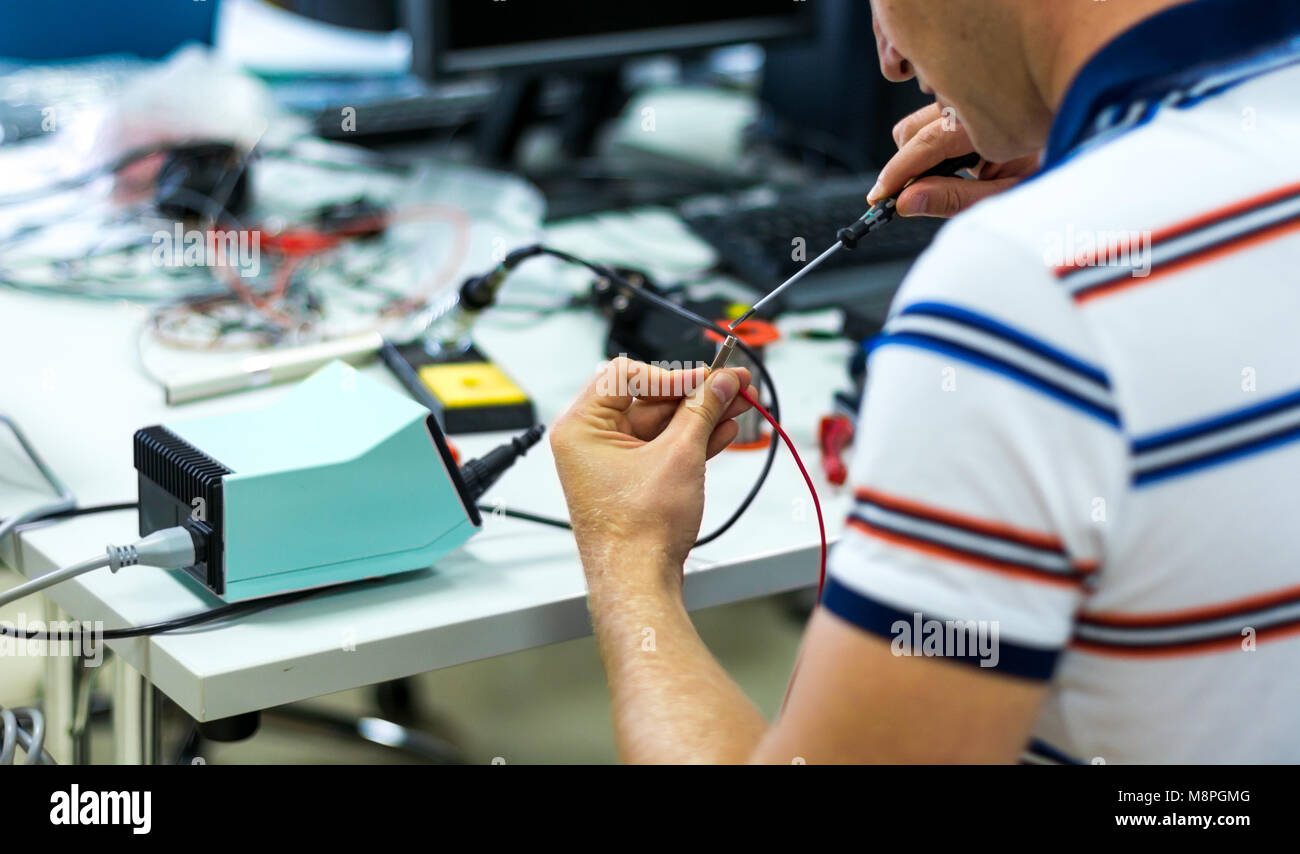 Electrician soldering wires Stock Photo - Alamy