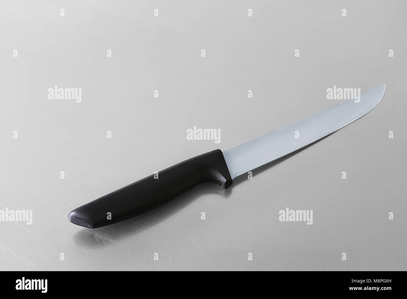kitchen knife on steel cutting table Stock Photo - Alamy