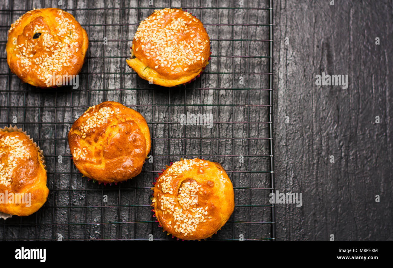 Homemade sesame muffins with seeds and grains on a baking net Stock ...