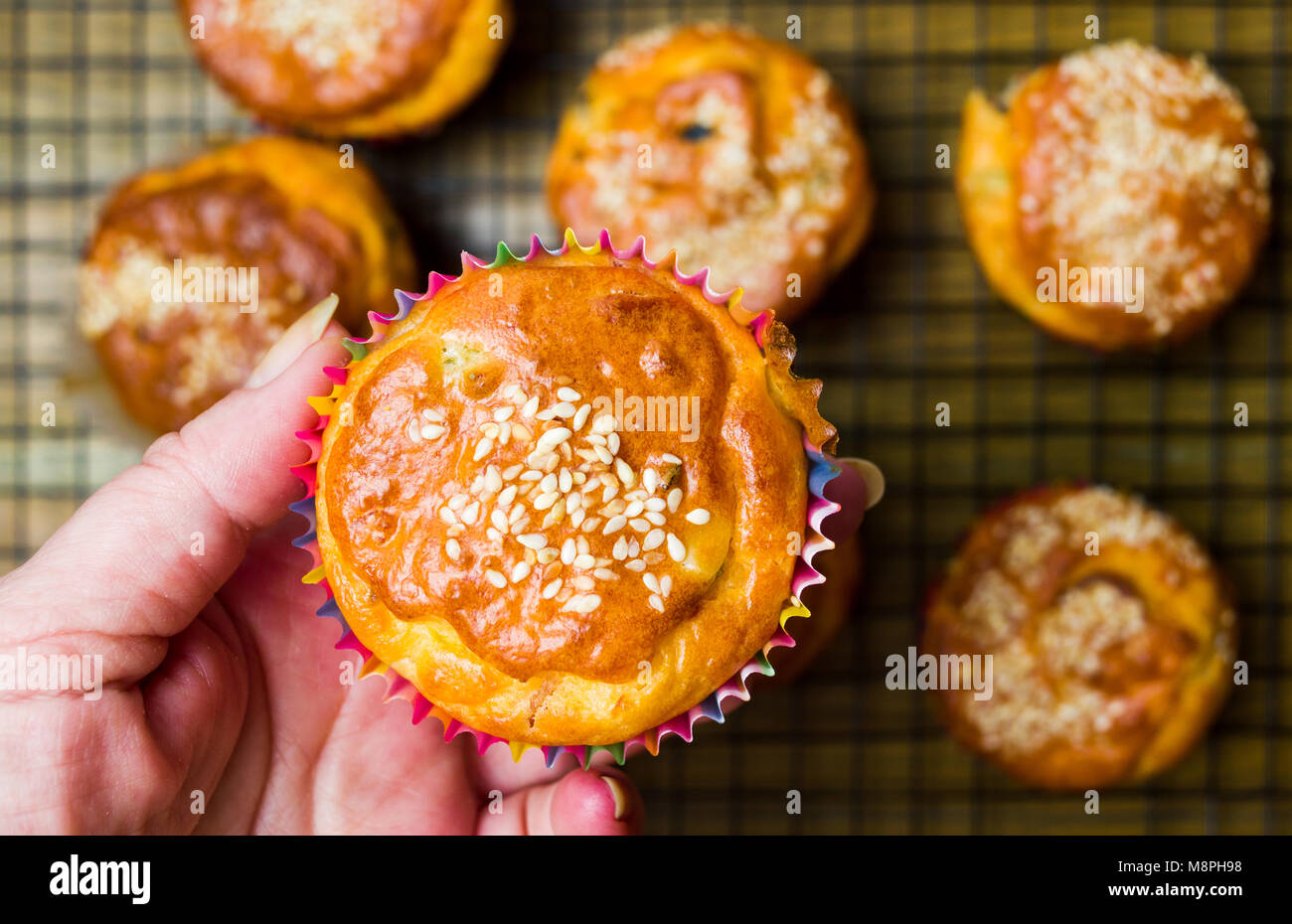 Hand holding a muffin with seeds and grains top view Stock Photo - Alamy