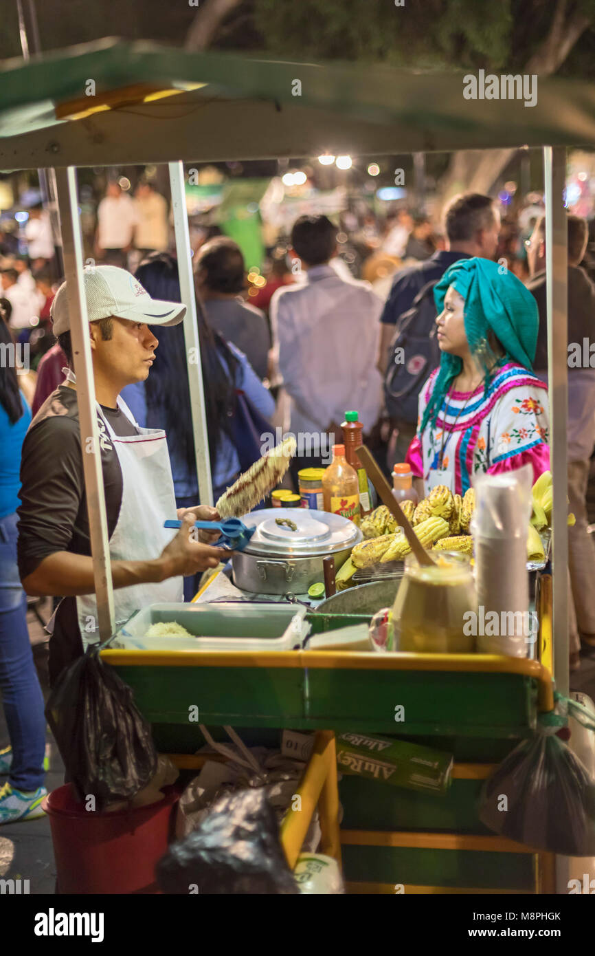 Oaxaca, Oax., Mexico - A food vendor sells corn from his cart in the ...