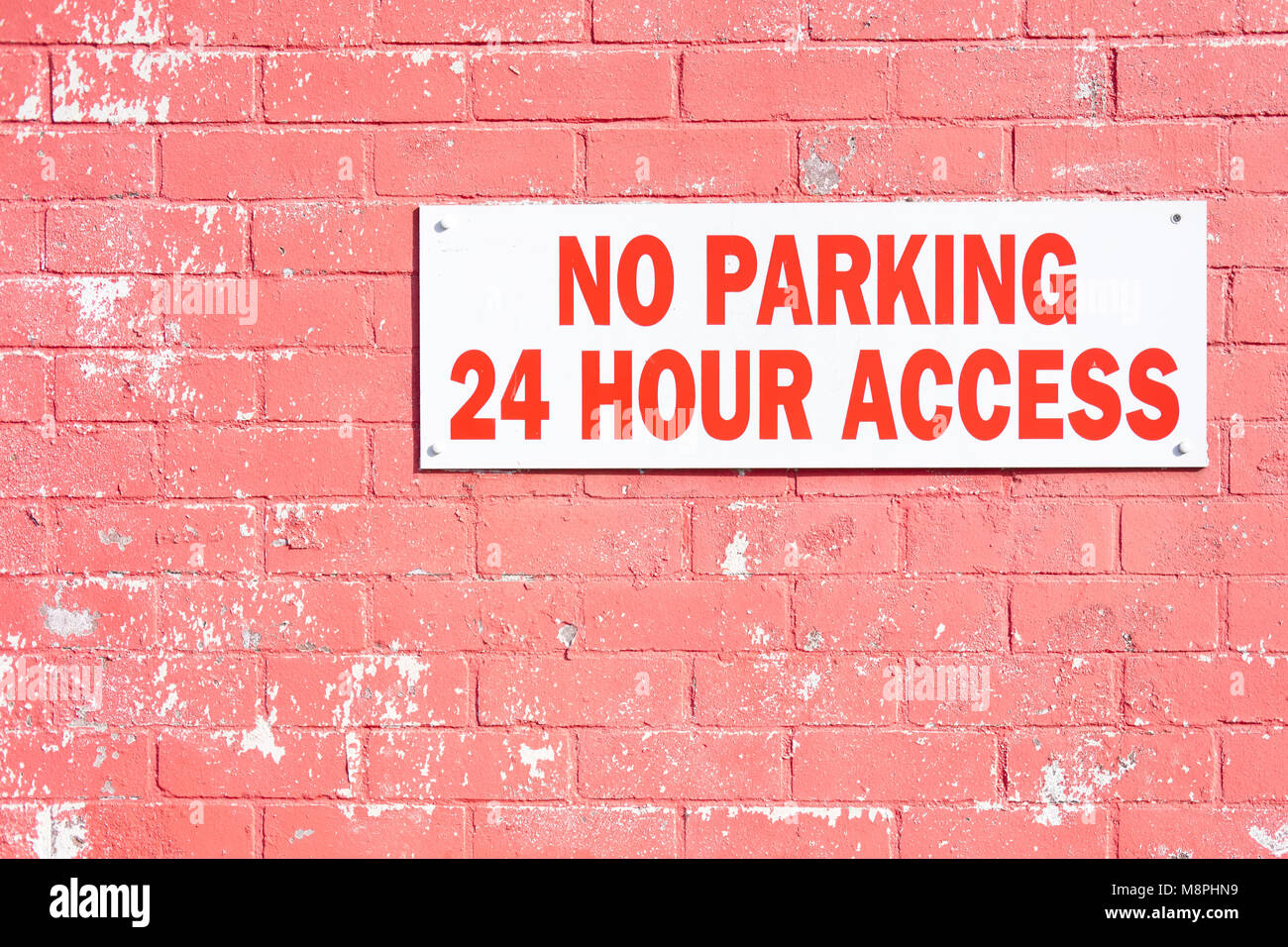 No parking 24 hour hr access required sign on red brick wall Stock ...