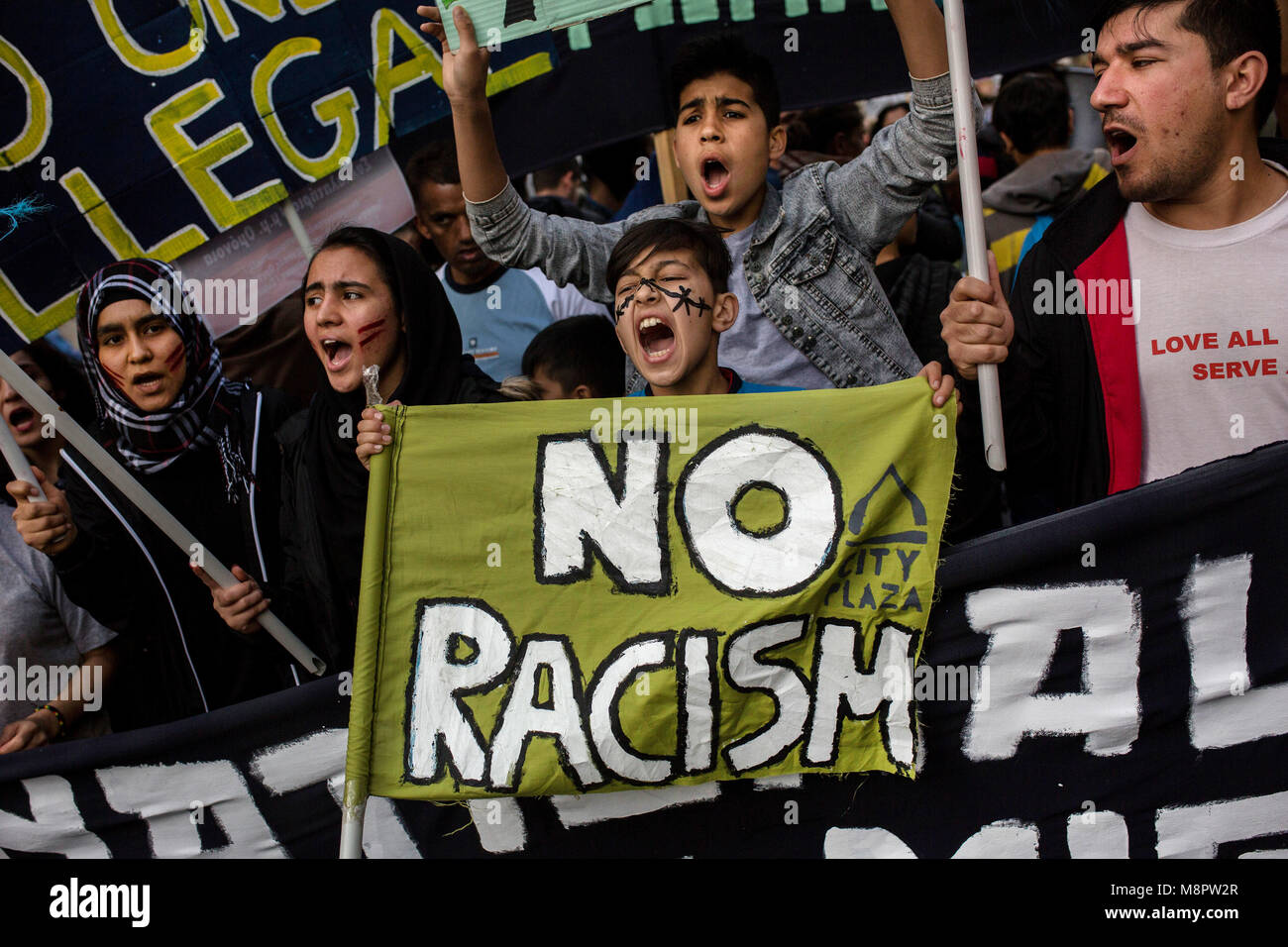 17 March 2018, Greece, Athens: A child carries a banner reading 'No ...
