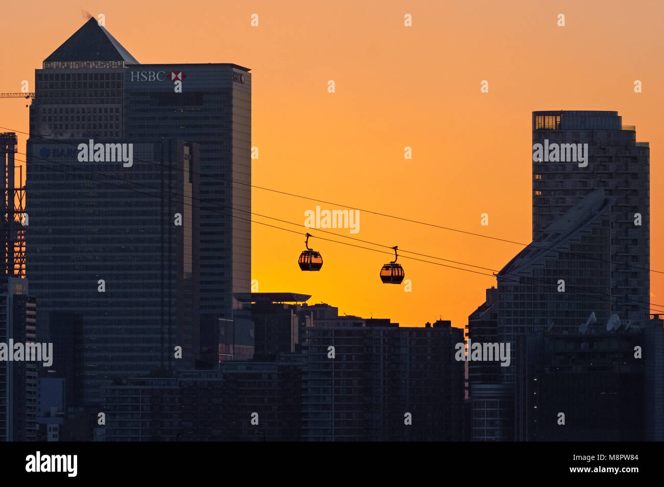 Silhouette of Canary Wharf skyscrapers and gondolas of the Emirates Air ...