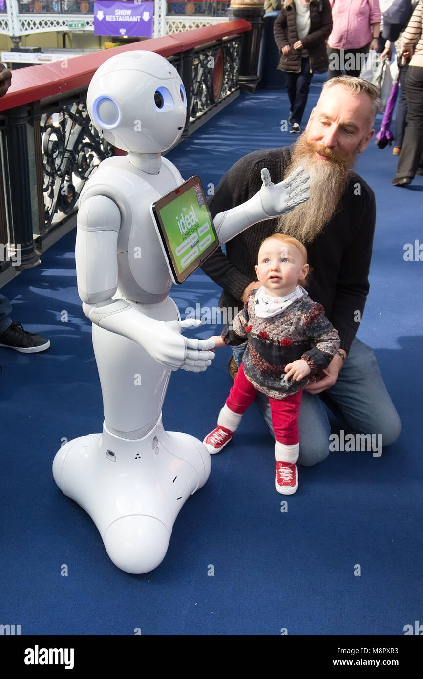 London, UK. 19 March 2018. Kid interacts with Pepper the Robot, by ...