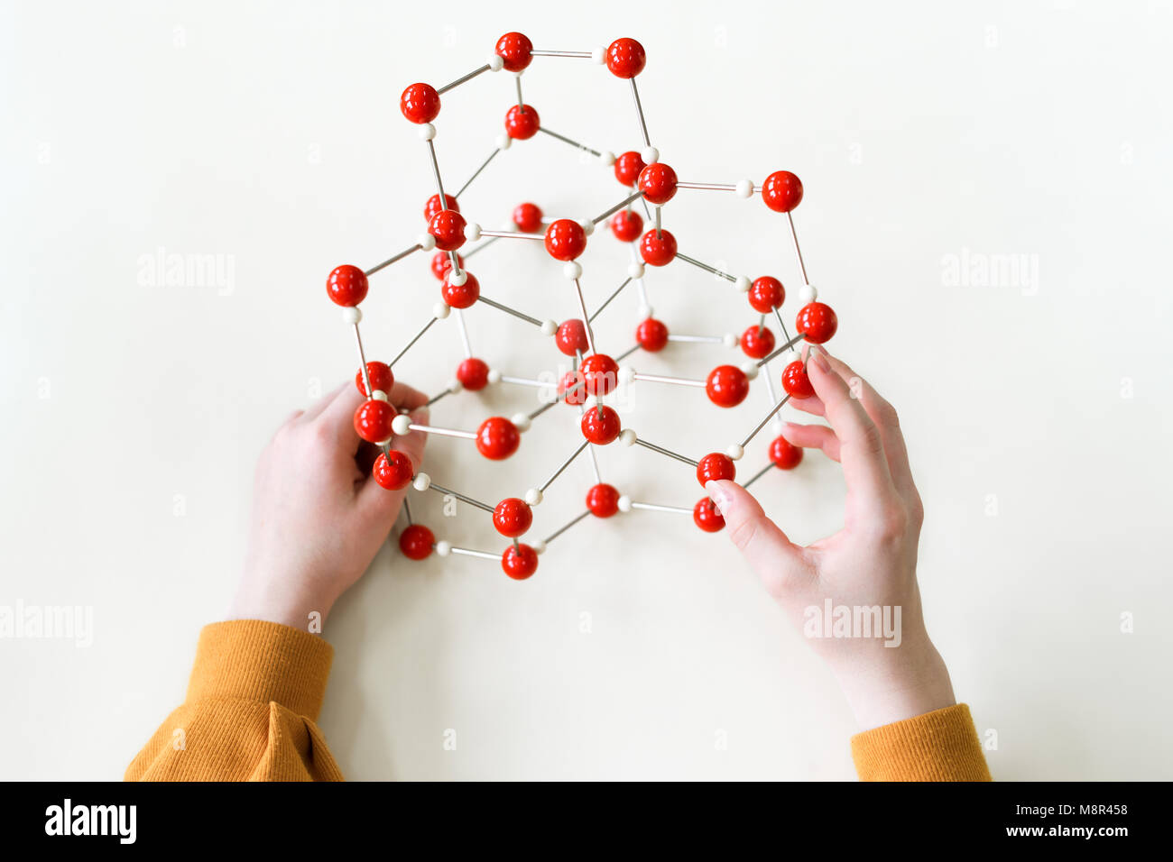 Student holding molecular structure model. Science class concept ...