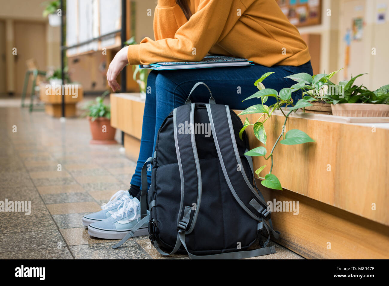Young unrecognisable depressed lonely female college student sitting in ...