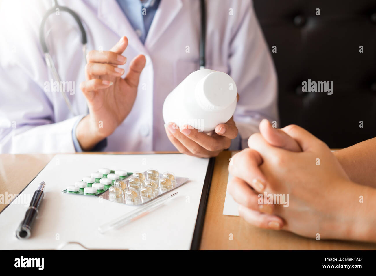 doctor hand holding tablet of drug and explain to patient in hospital ...