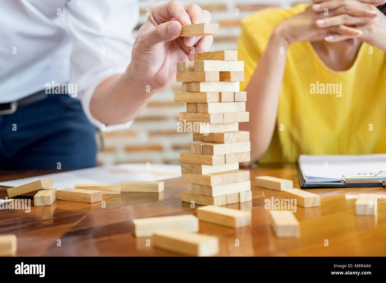 Group of business creative people building tower by wooden blocks ...