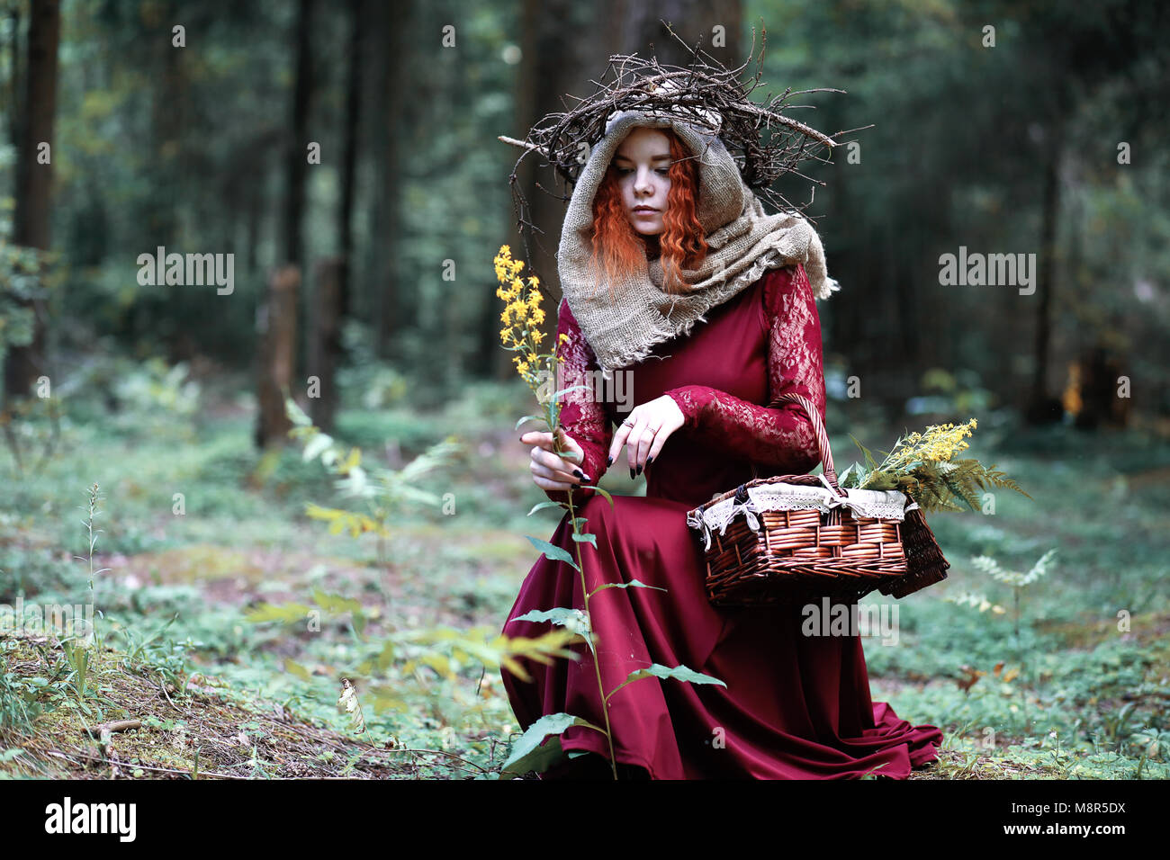 The red-haired witch holds a ritual with a crystal ball Stock Photo - Alamy