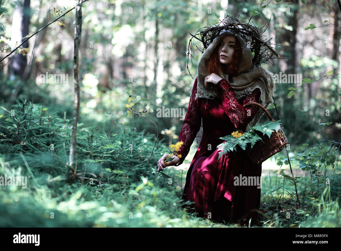 The red-haired witch holds a ritual with a crystal ball Stock Photo - Alamy