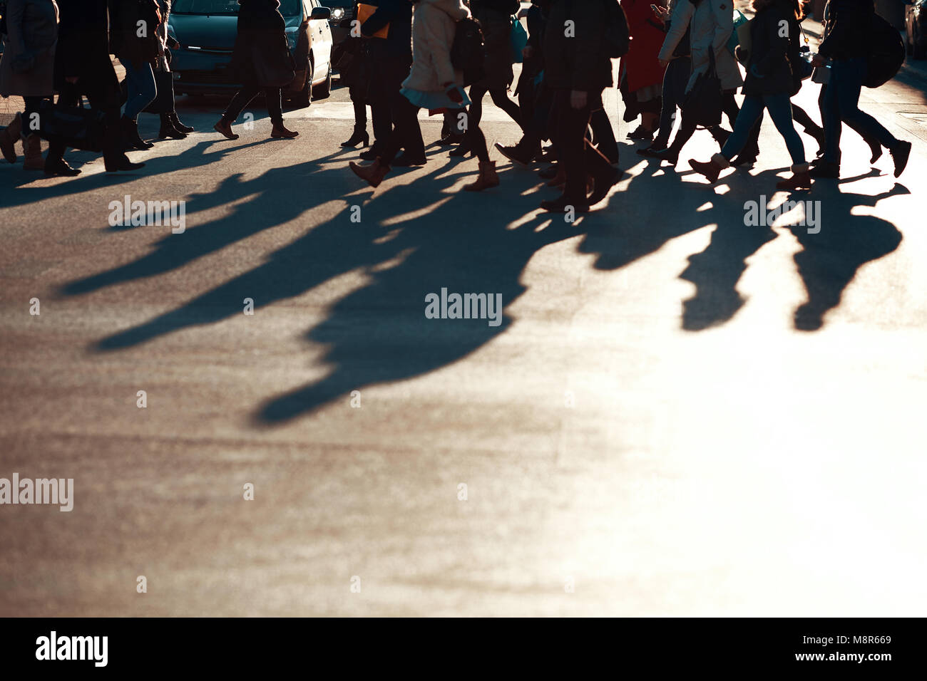 People walking on the street with sunset background Stock Photo - Alamy