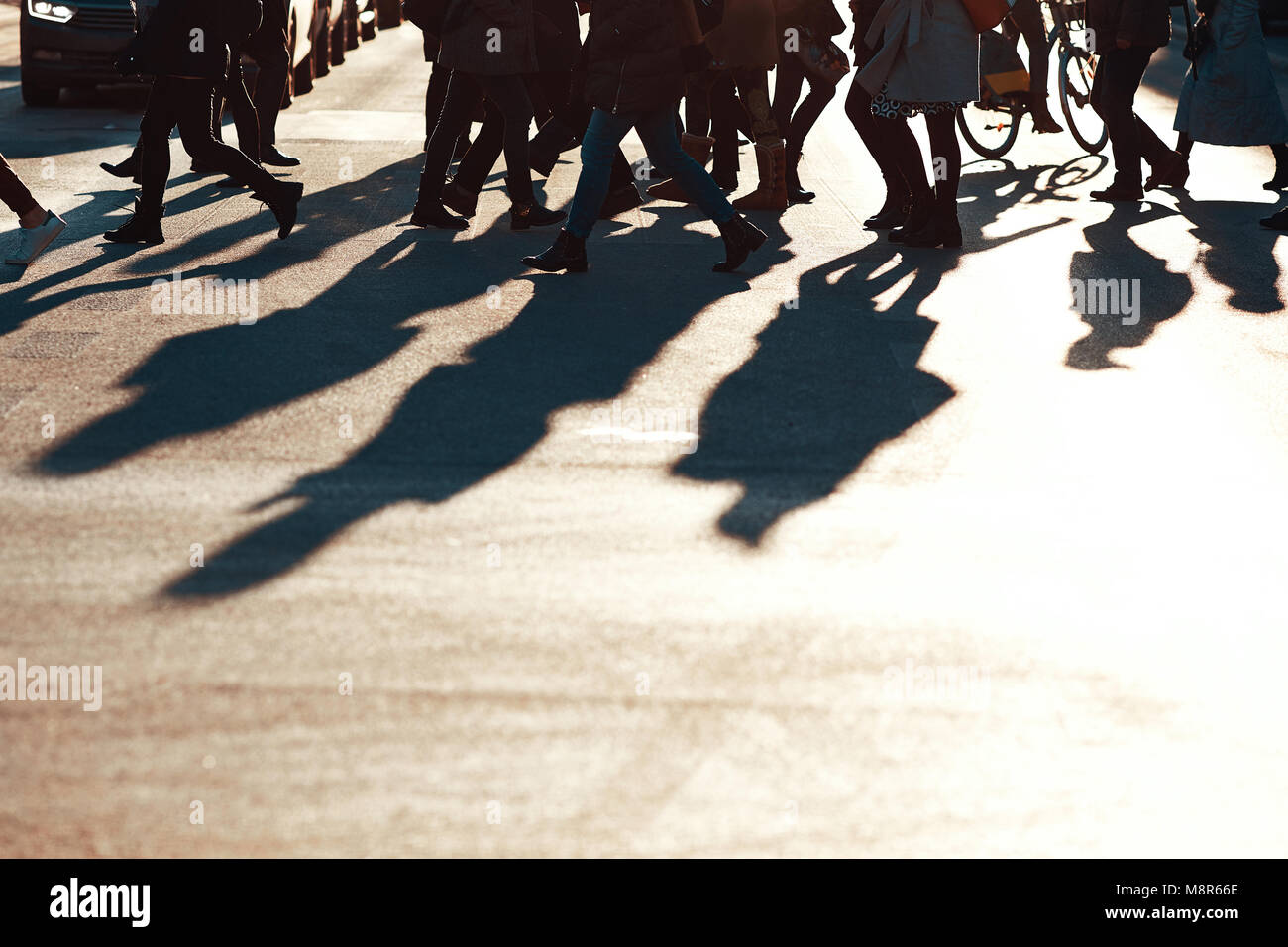 People walking on the street with sunset background Stock Photo - Alamy