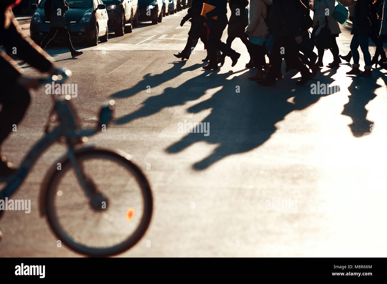 People walking on the street with sunset background Stock Photo - Alamy