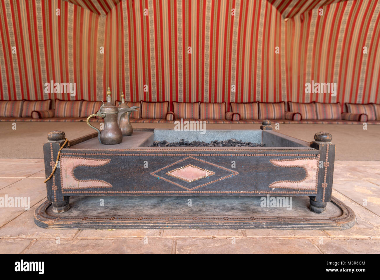 Interior of a large traditional arab tent lined with red patterned ...
