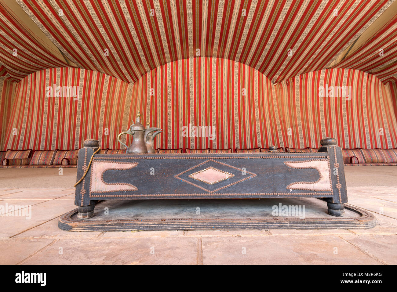 Interior of a large traditional arab tent lined with red patterned ...