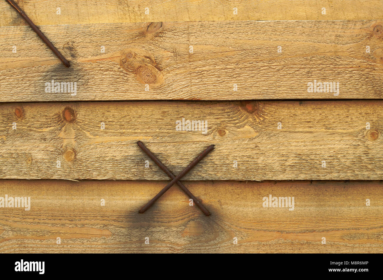 Staples hammered into the wooden beams.The boards form a single array ...