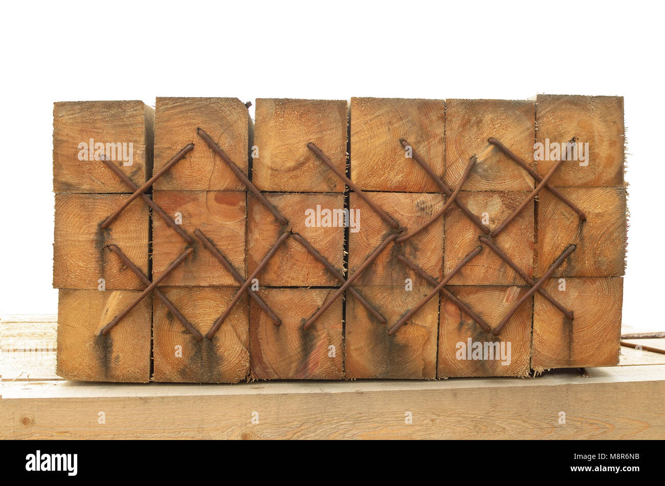 Staples hammered into the wooden beams.The boards form a single array ...