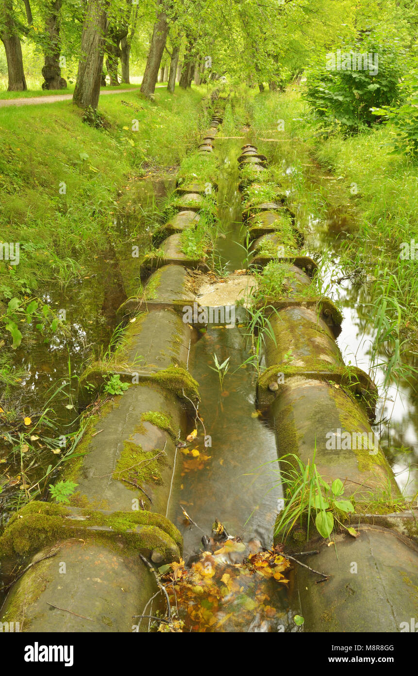 The ancient water supply system in the Park.Tubes in two rows padded to ...