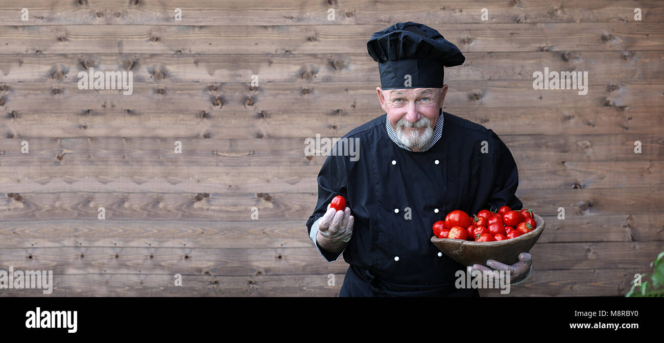 Chef old in uniform with vegetables Stock Photo - Alamy