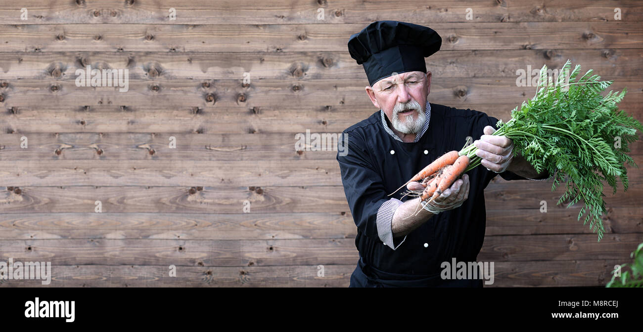 Chef old in uniform with vegetables Stock Photo - Alamy