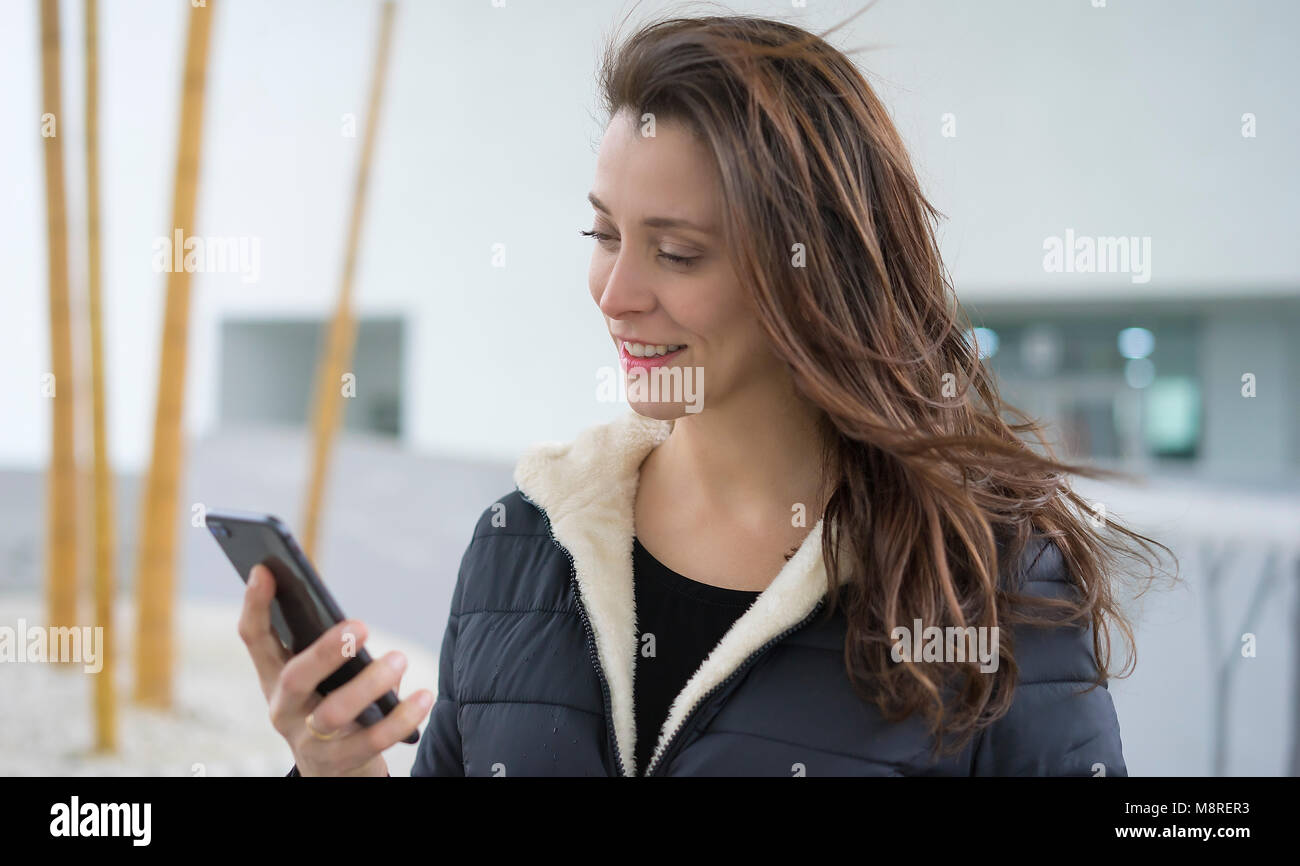 talking, Brown-haired woman in video conference with the mobile ...