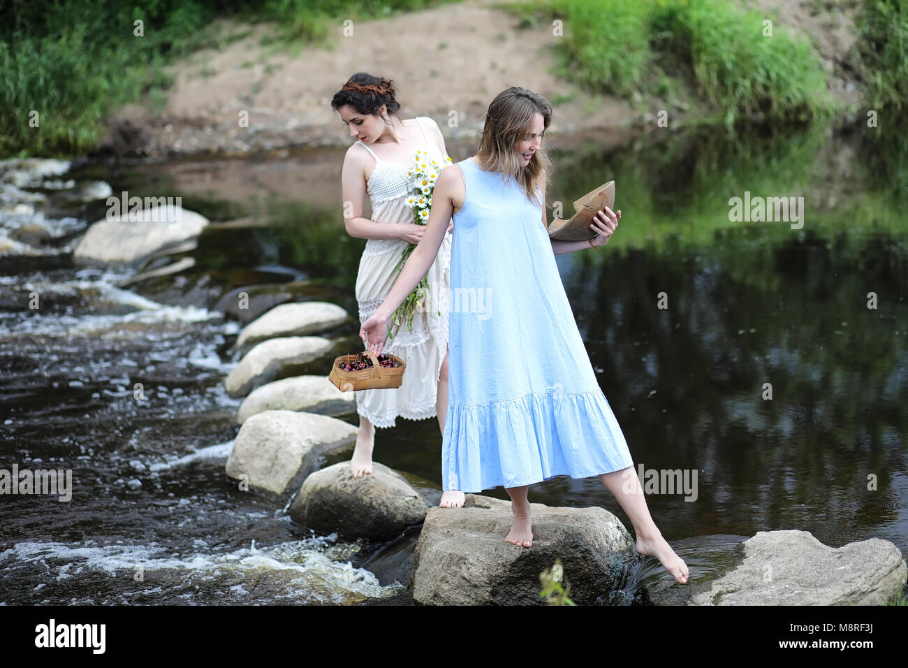 Beautiful girls in dresses on the river Stock Photo - Alamy
