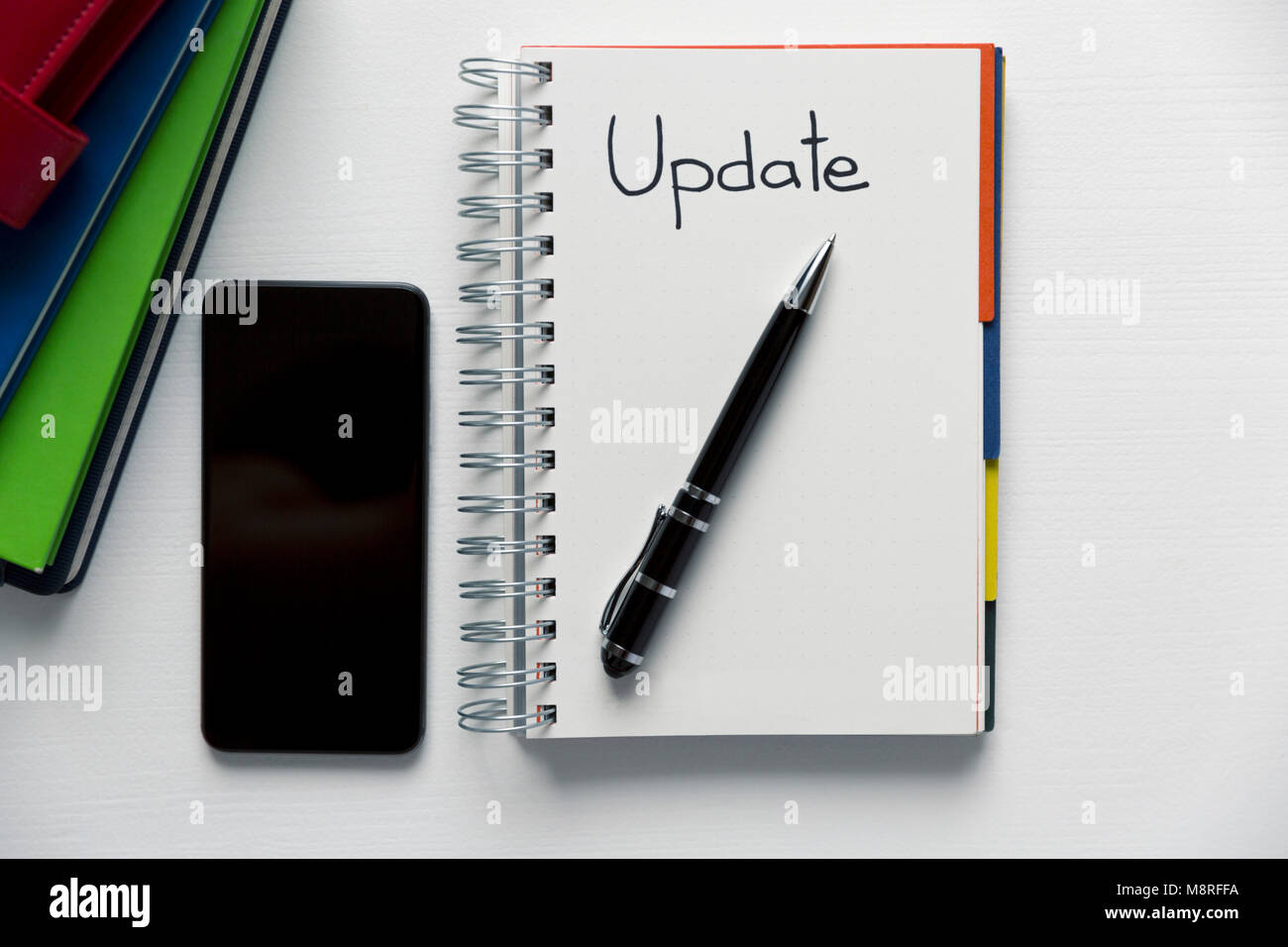 Update - handwritten text in a notebook on a desk. Project update ...
