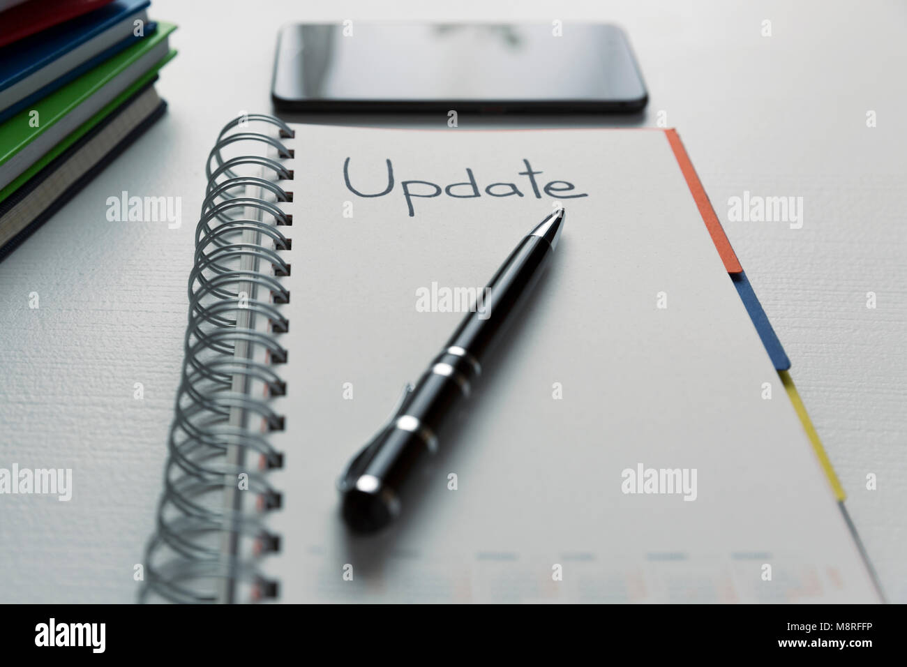 Update - handwritten text in a notebook on a desk. Project update ...