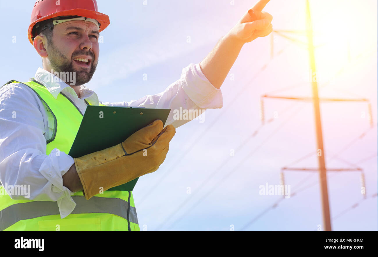 An electrician in the fields near the power transmission line Stock ...