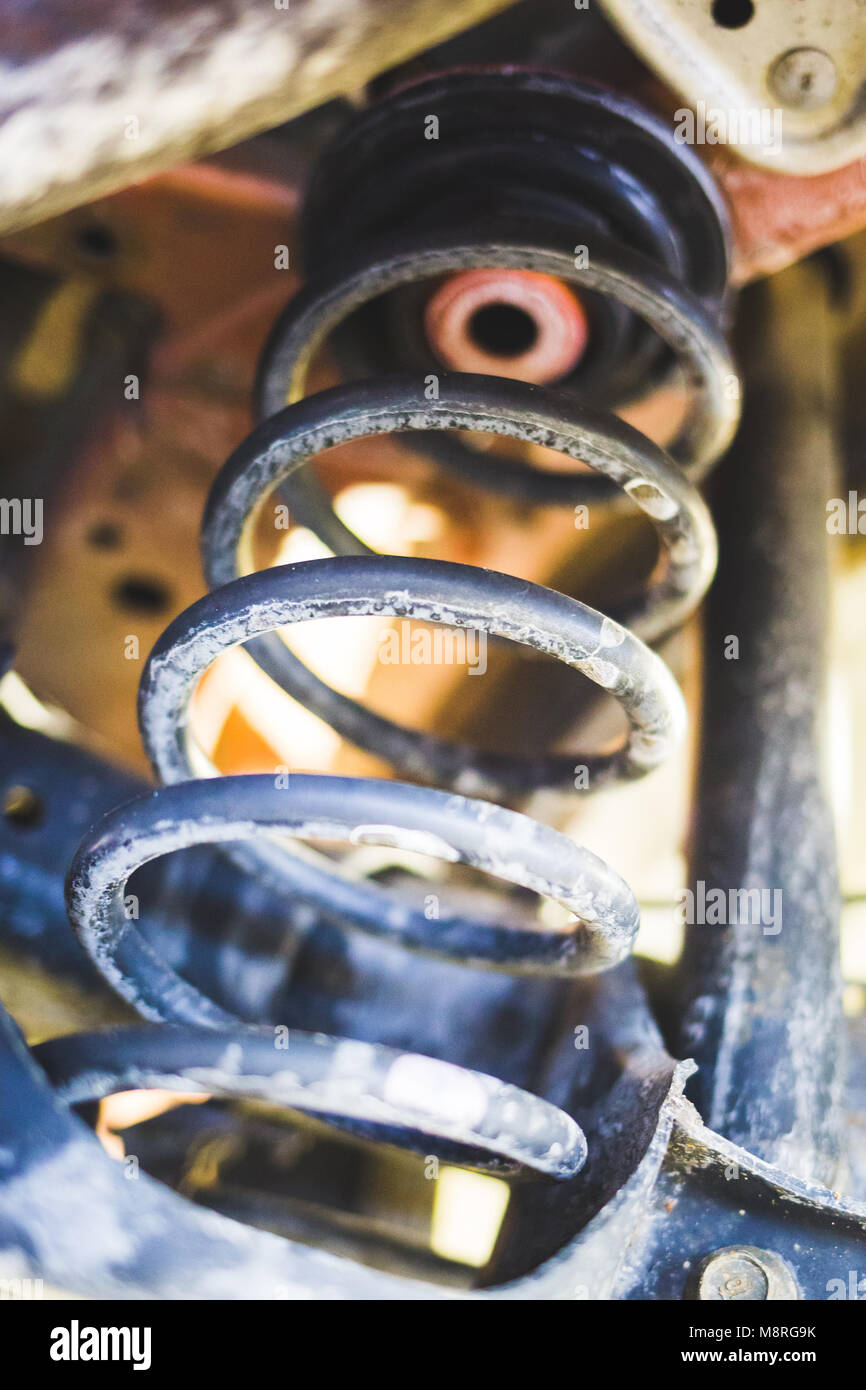Big rusty car spring needs to be repaired Stock Photo - Alamy