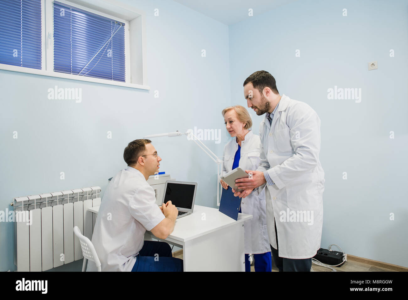 Professional doctors discussing about disease at office Stock Photo - Alamy