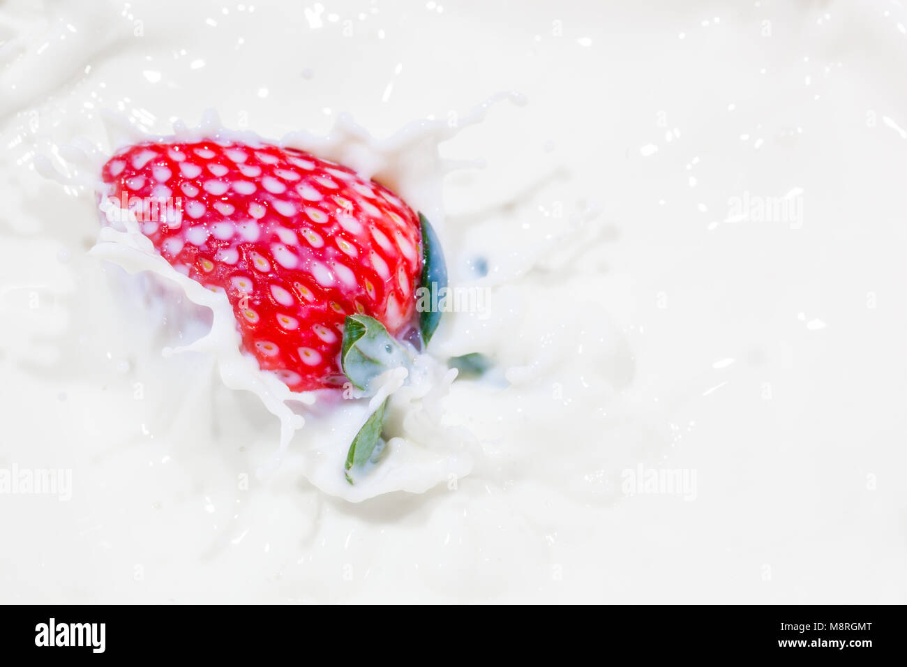Strawberry falling into milk hi-res stock photography and images - Alamy
