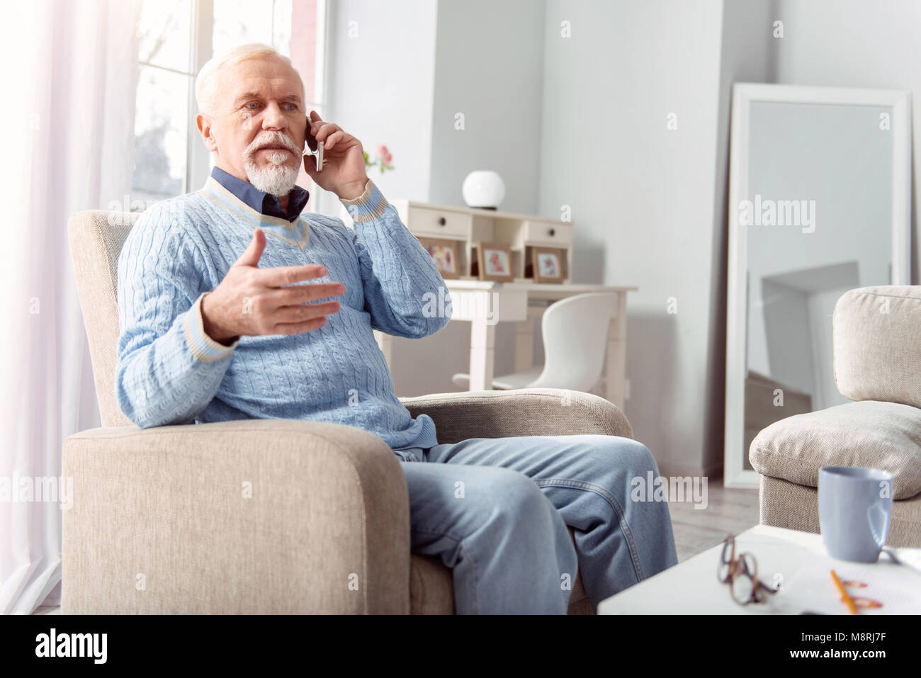 Handsome senior man talking on the phone with his friend Stock Photo ...