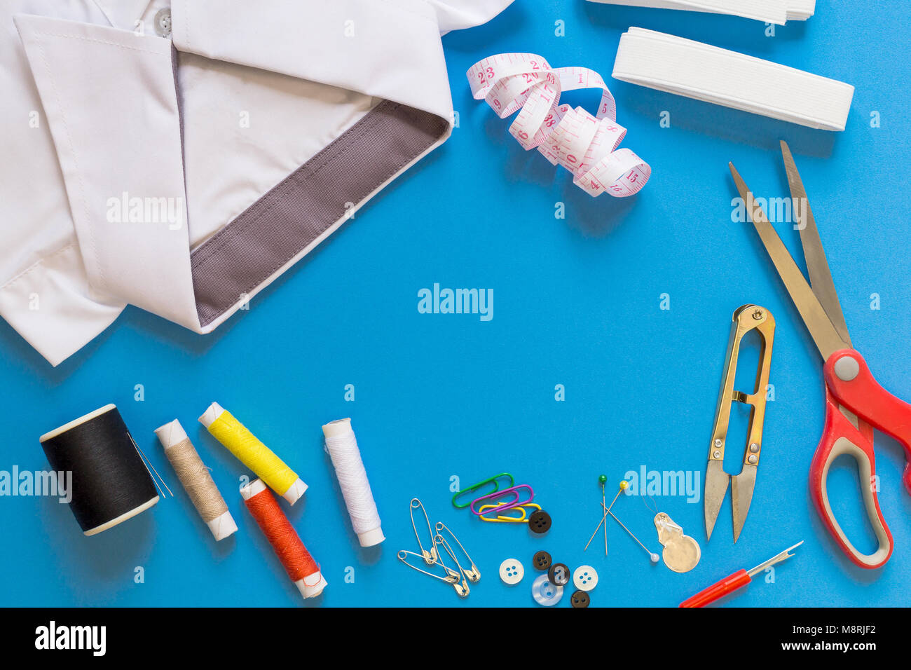 Sewing accessories on blue background Stock Photo - Alamy