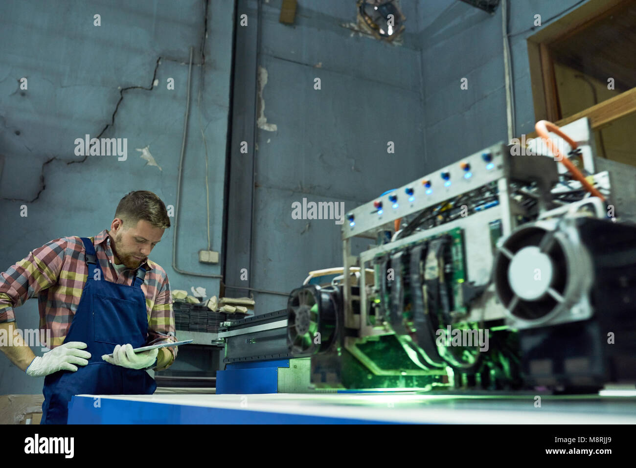 Worker Operating CNC Equipment at Factory Stock Photo - Alamy