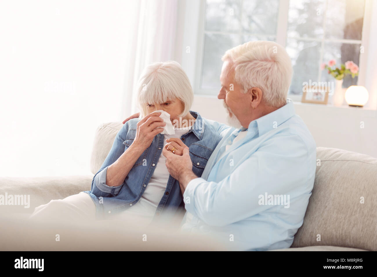 Loving senior man cheering up his crying wife Stock Photo - Alamy