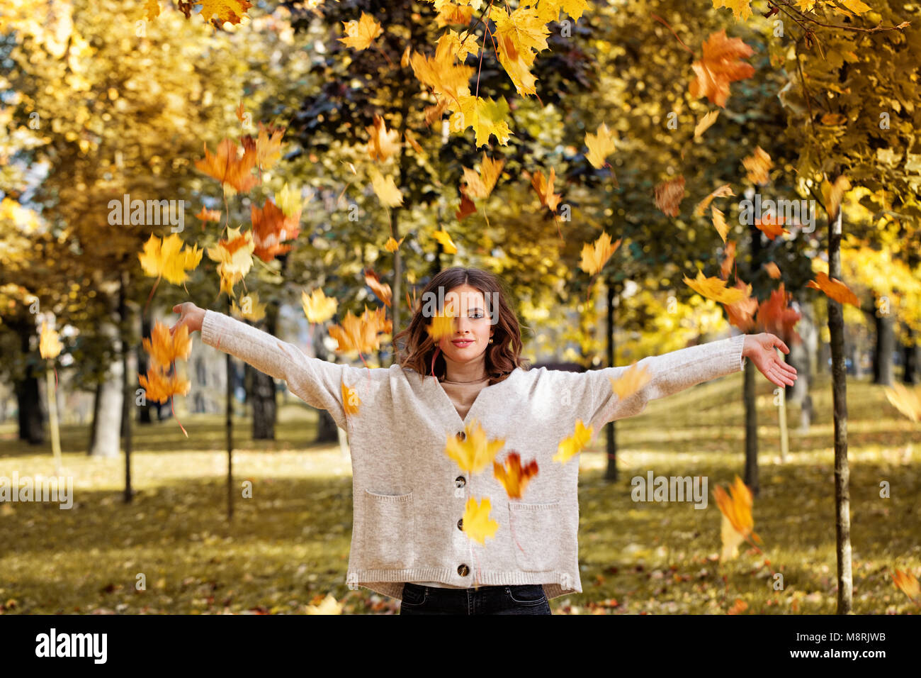 Autumn Woman Fashion Model with Fall Leaves in the Autumn Park Outdoors ...