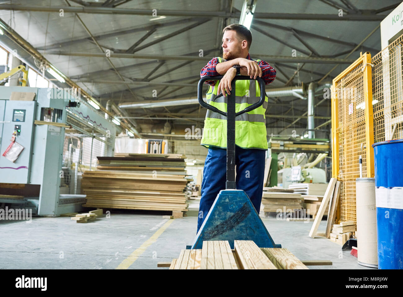 Young Man Moving Boards in Warehouse Stock Photo - Alamy