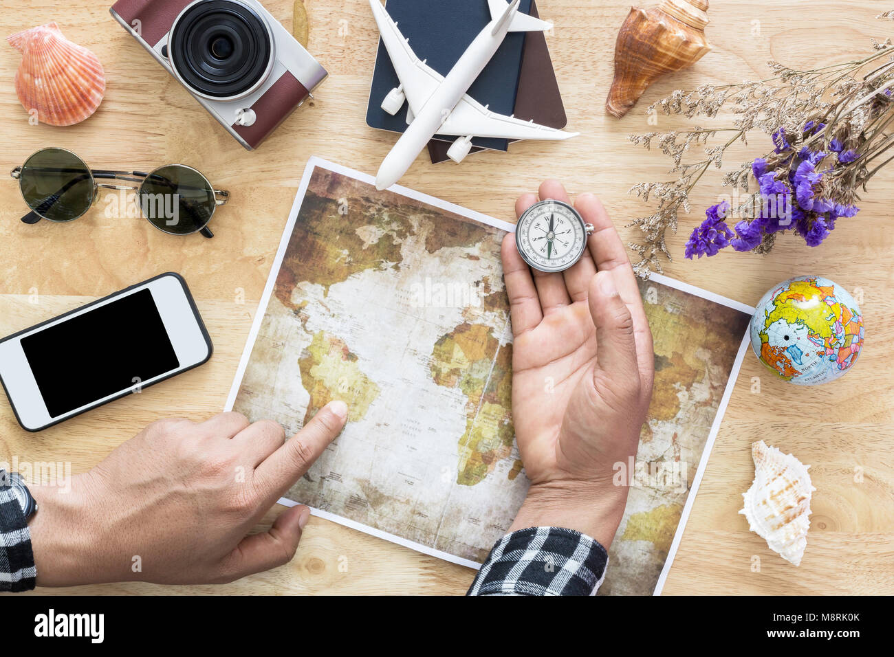 Young man planning travel on vacation trip with map. Top view Stock ...