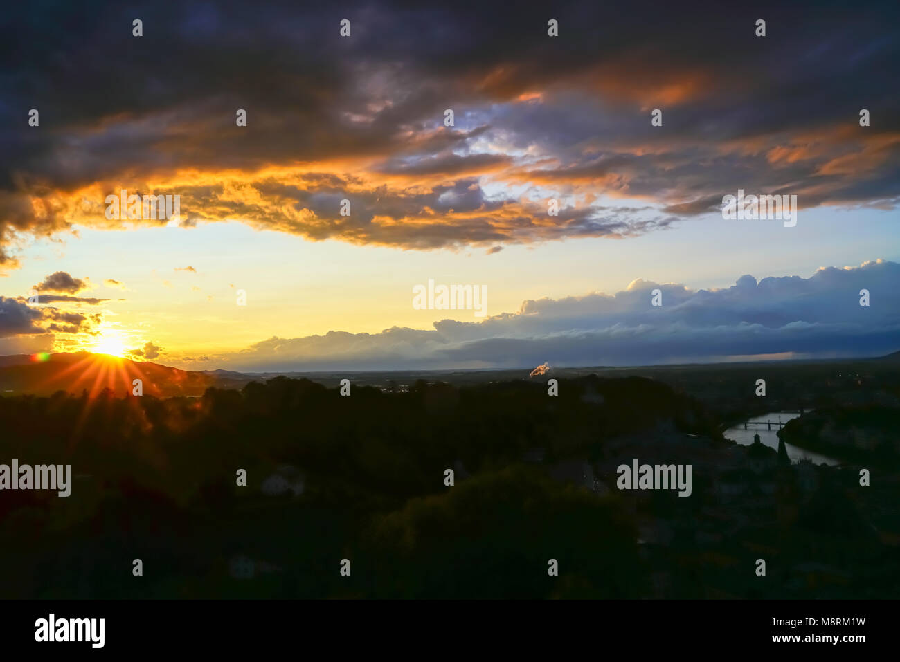 Dark firery red and black clouds as sunsets over European landscape ...