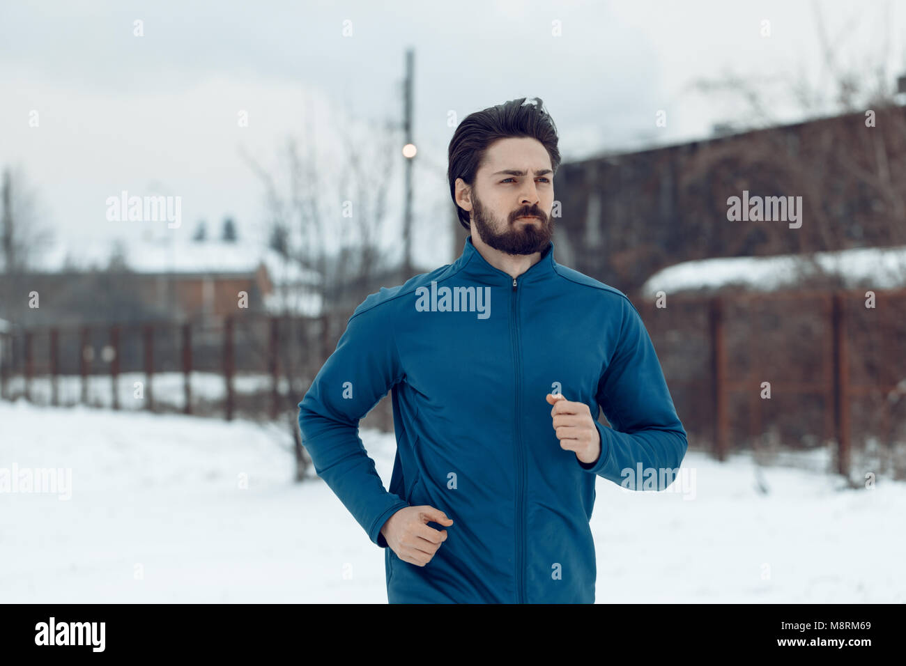 Active young man running and doing exercises in the public place during ...